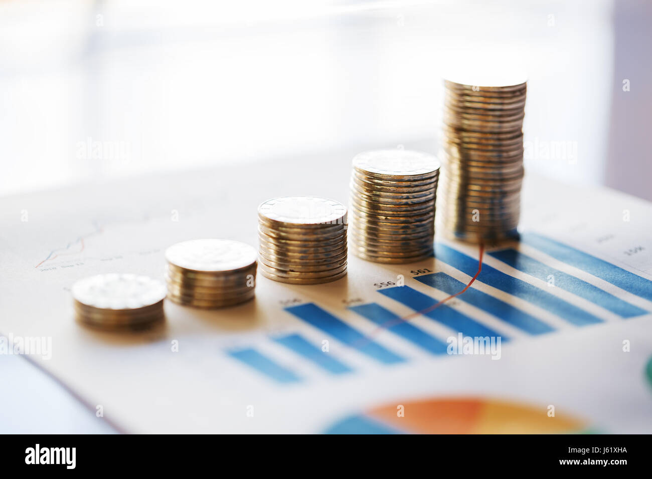 Stack of growing coins on bar graph Stock Photo - Alamy