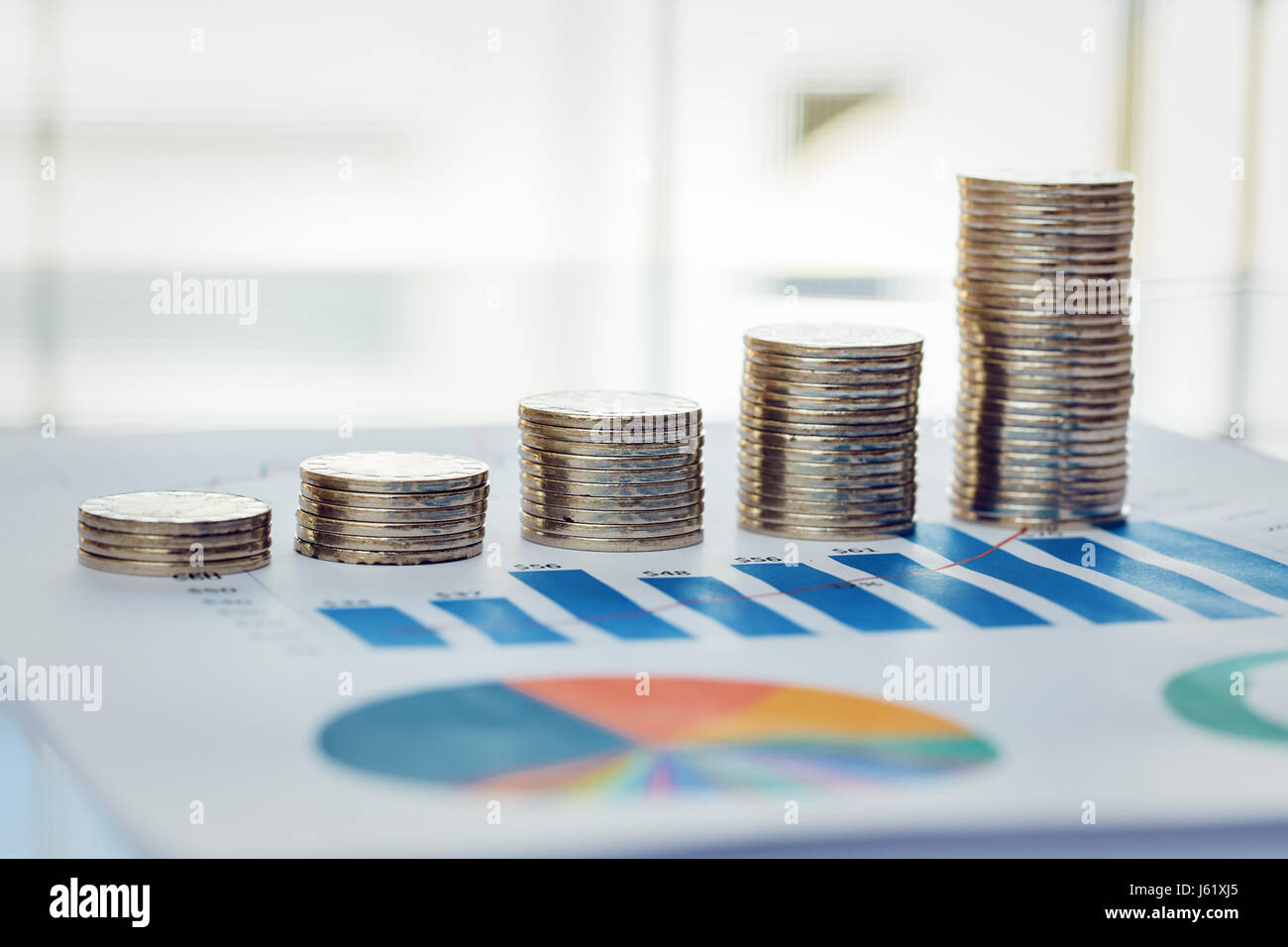 Stack of coins on paper of financial chart Stock Photo - Alamy