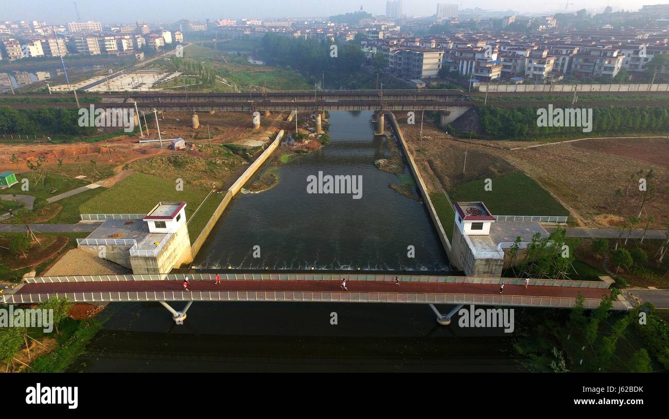 Xin'gan. 18th May, 2017. Citizens do morning exercise inside an ...