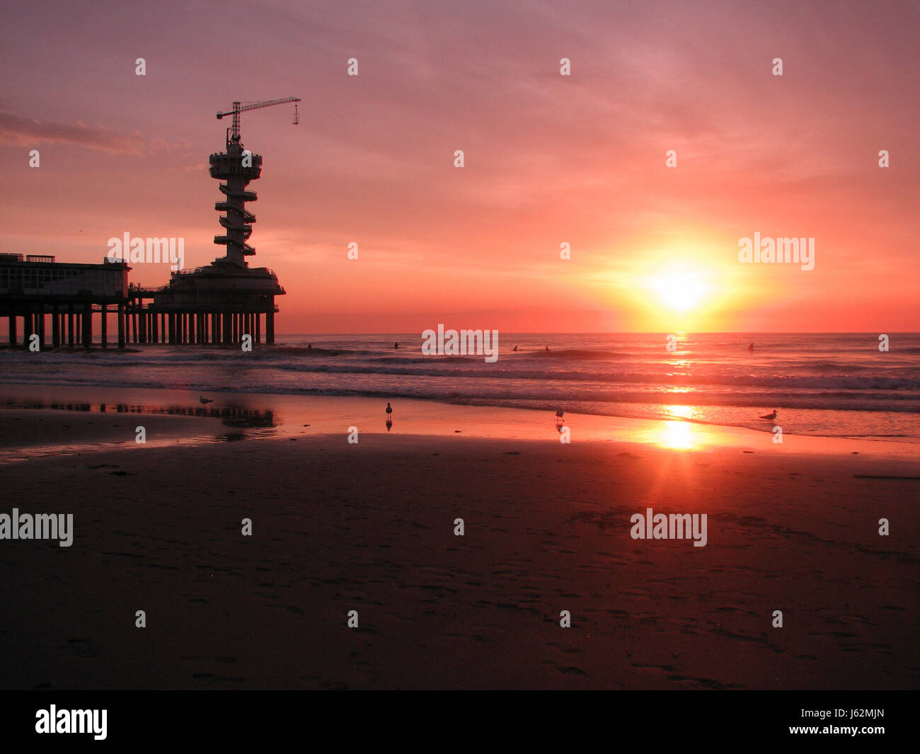 sunset waves salt water sea ocean water tower sunset columns beach seaside the Stock Photo - Alamy