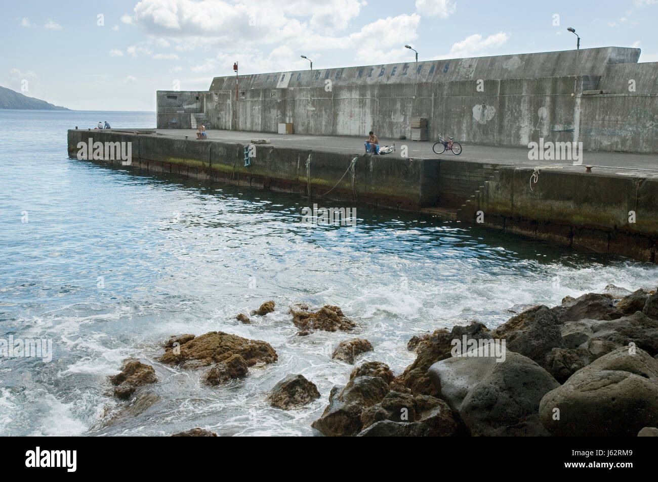 concrete barrier breakwater pier port quay humans human beings people ...
