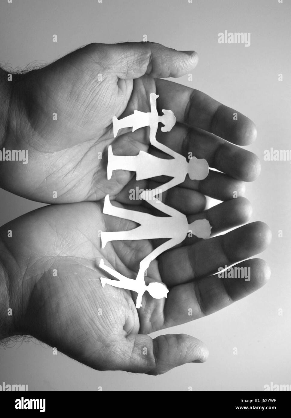 two hands holding a paper cut Stock Photo - Alamy