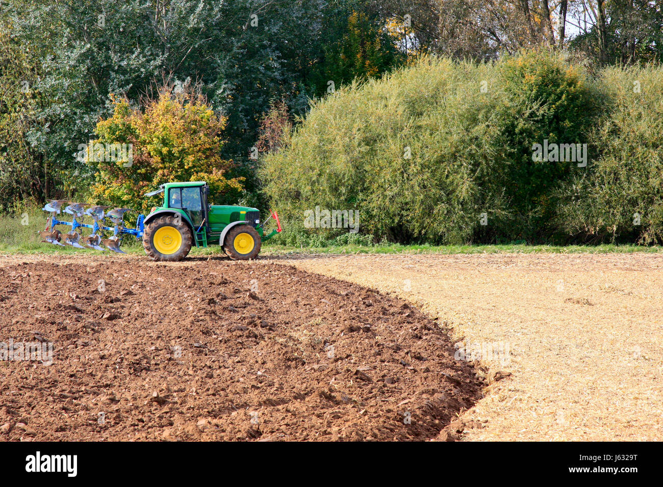 field acre tractor plough field work fall autumn blue agrarian colour ...