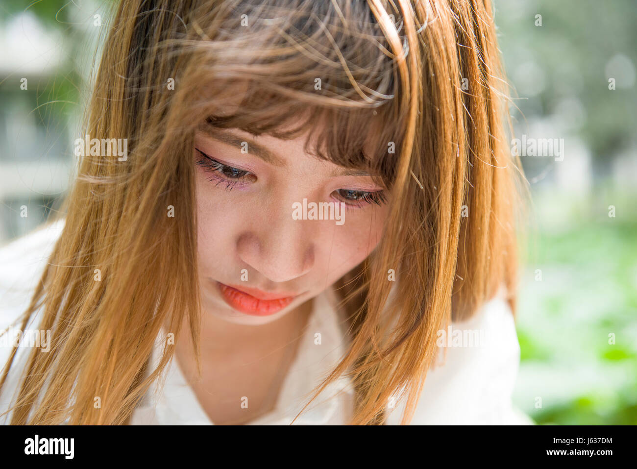 Young sad girl outdoor. Closeup of young asian girl in summer day Stock ...