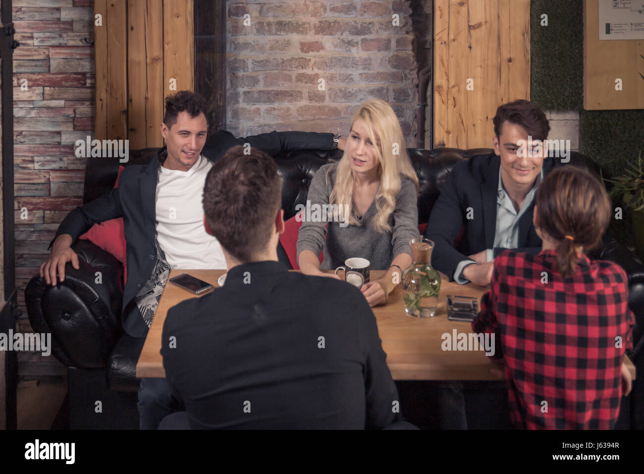 small group of people talking, sitting sofa, coffee shop table Stock ...