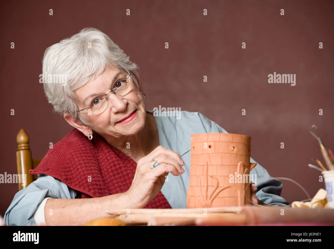 female creative clay ceramic elderly artist painter grey gray elder ...