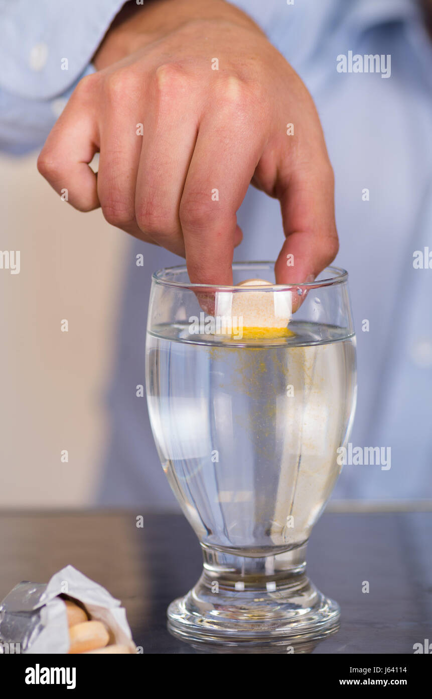 Hand drop dissolve tablet water hi-res stock photography and images - Alamy