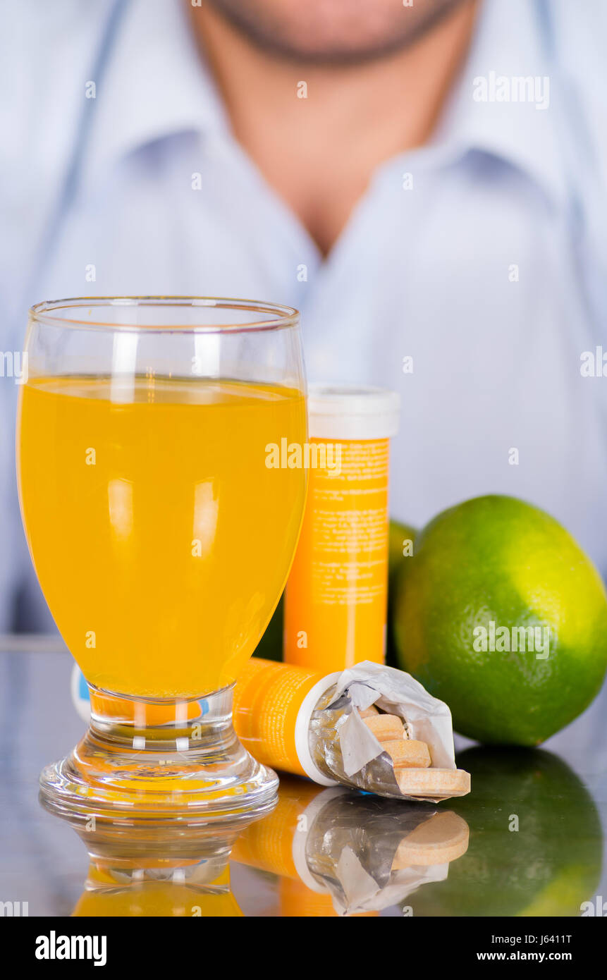 Lemon, pills of vitamin C and a glass of vitamin C dissolved over the ...