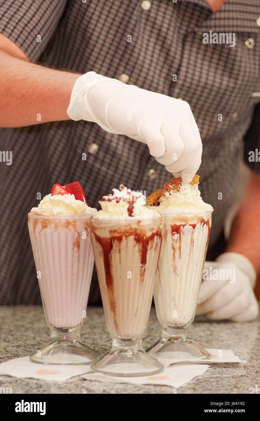 Handsome man having a milkshake with a plastic straw Stock Photo - Alamy