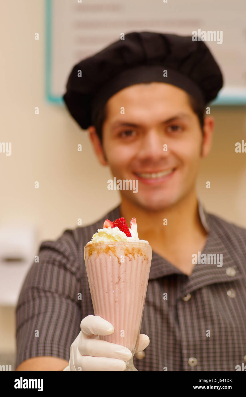 Handsome man with a cheff hat poiting in from of him a milkshake Stock ...