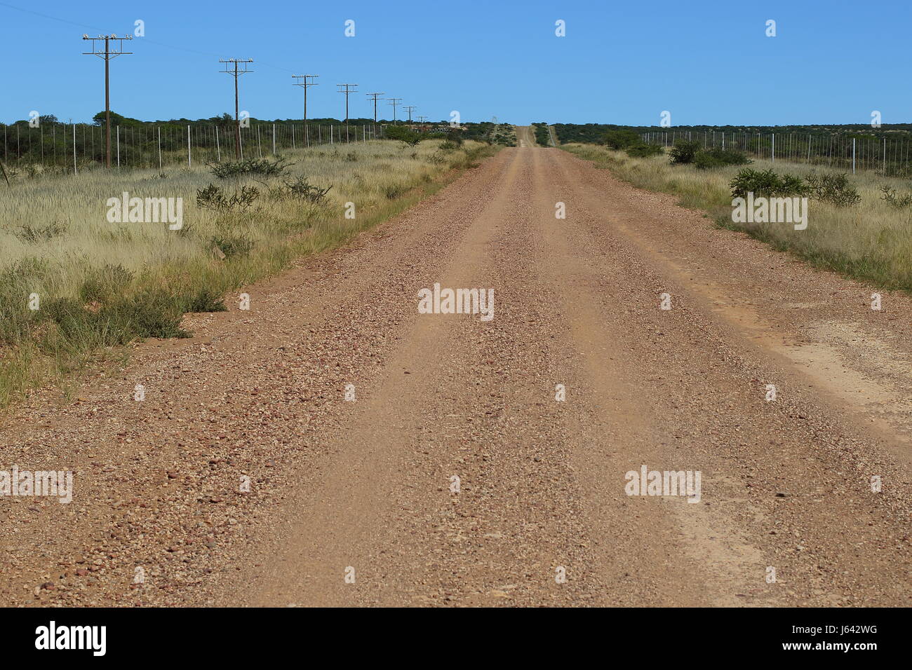 A long and dusty road winds through the countryside Stock Photo - Alamy