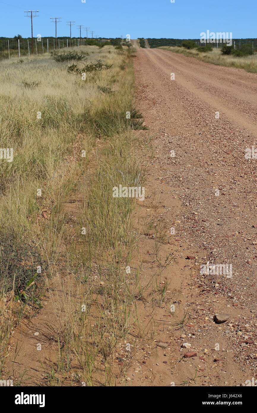 A long and dusty road winds through the countryside Stock Photo - Alamy