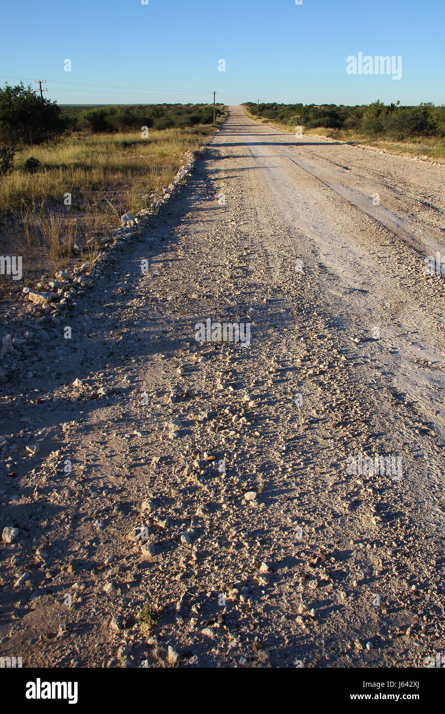 A long and dusty road winds through the countryside Stock Photo - Alamy