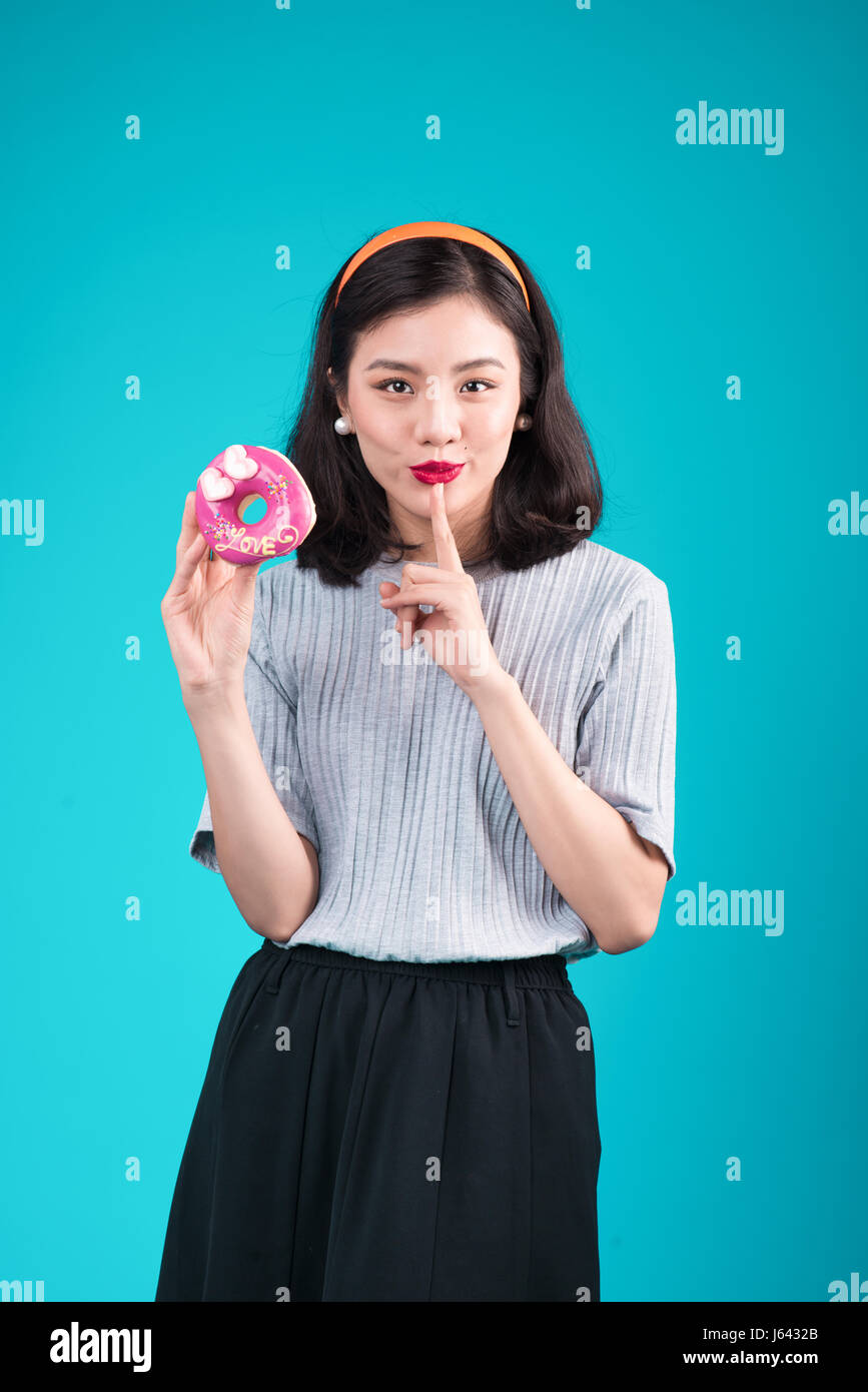 Asian beauty girl holding pink donut. Retro joyful woman with sweets ...
