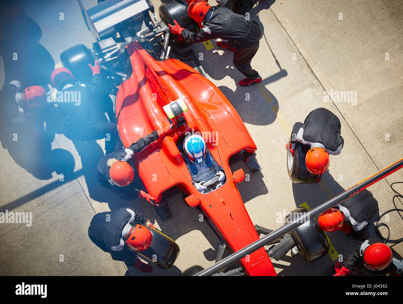Overhead pit crew working on formula one race car in pit stop Stock ...