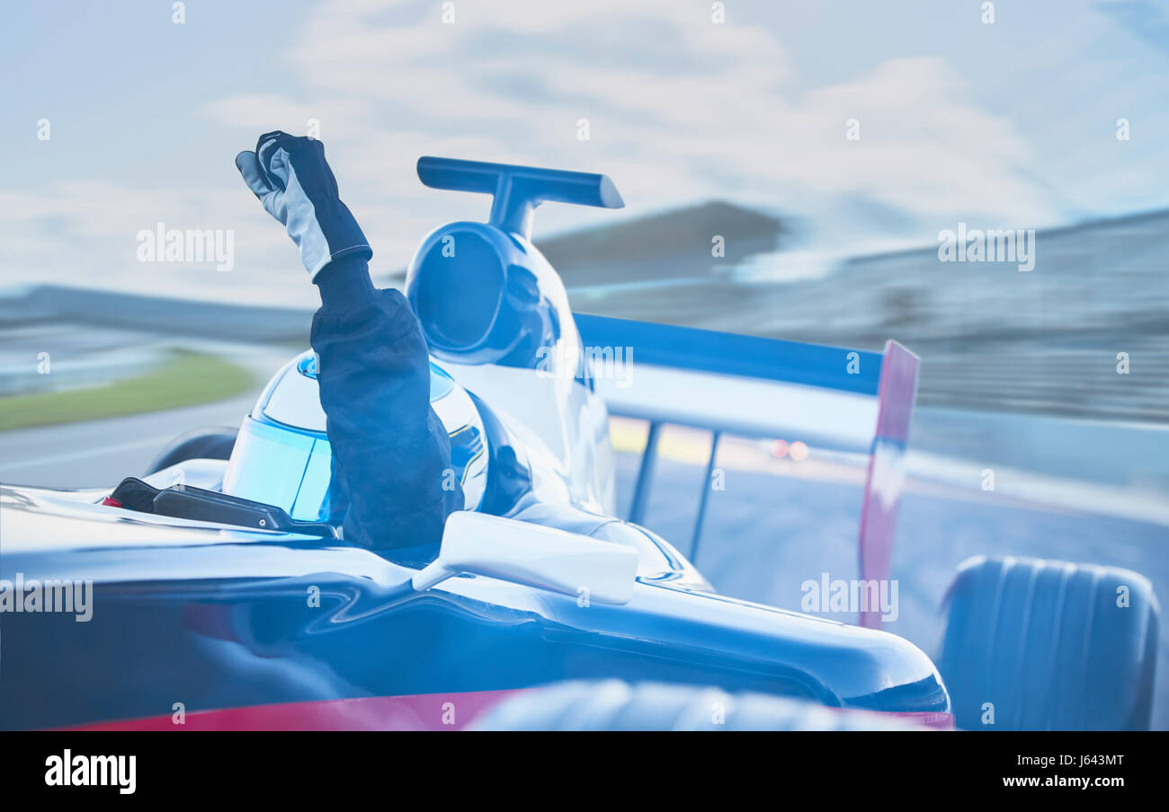 Formula one race car driver cheering, gesturing with fist on sports ...