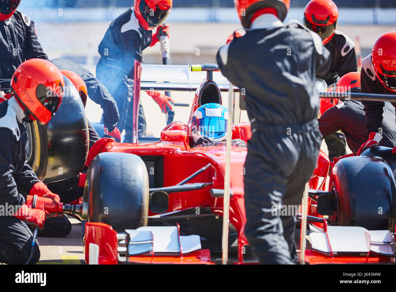 Pit crew working on formula one race car in pit lane Stock Photo - Alamy