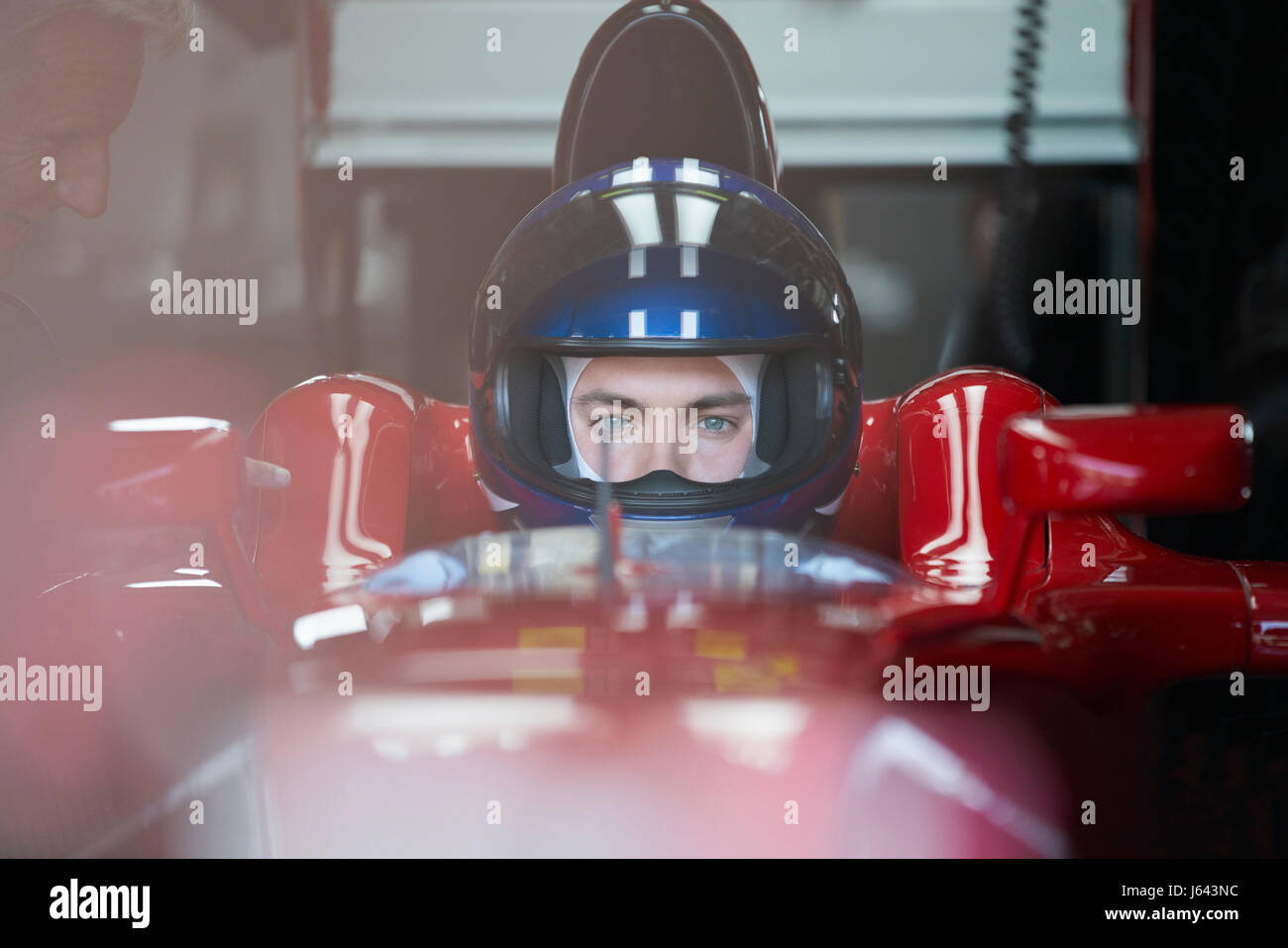 Focused formula one race car driver wearing helmet Stock Photo - Alamy