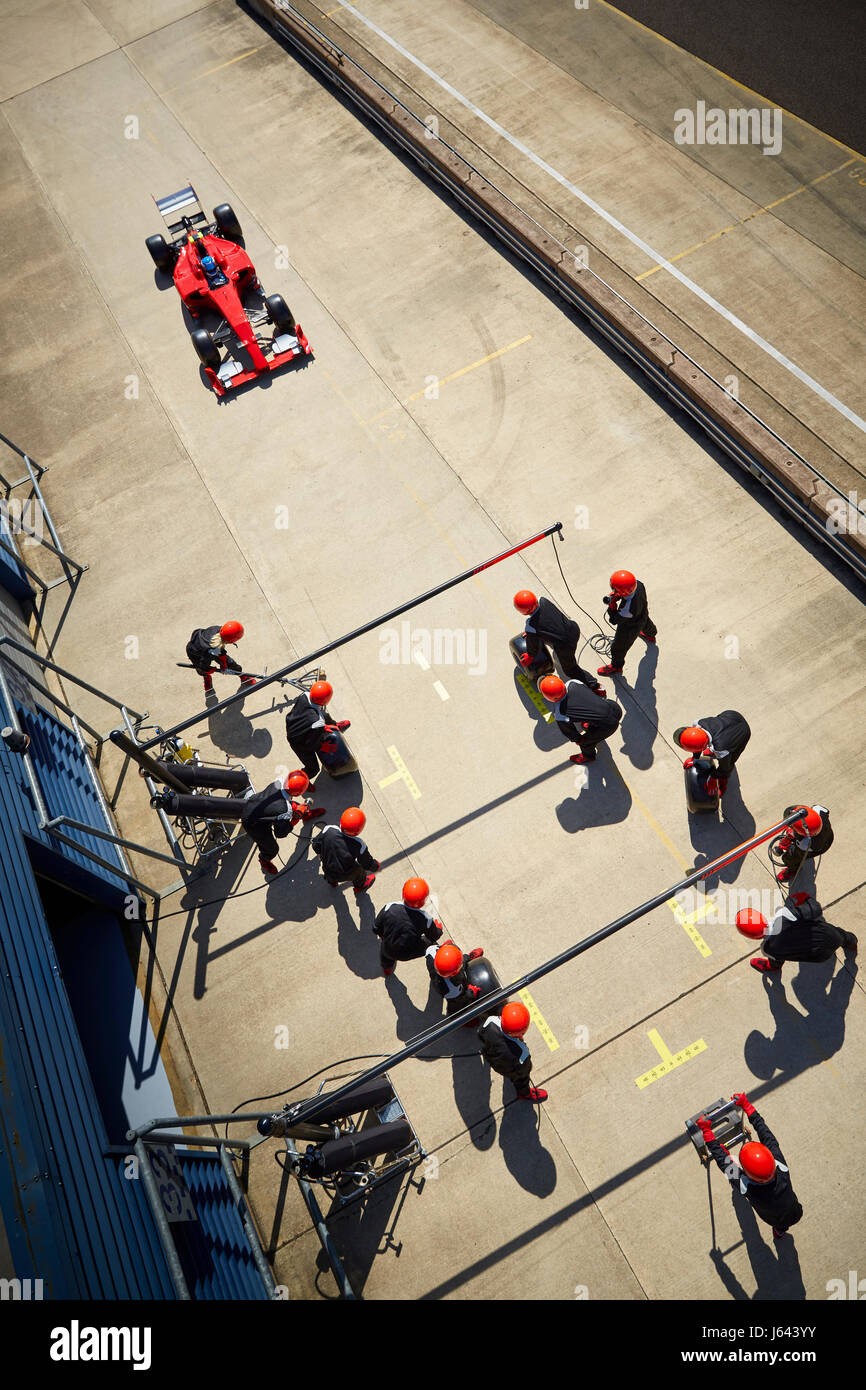 Pit crew ready for nearing formula one race car in pit lane Stock Photo ...