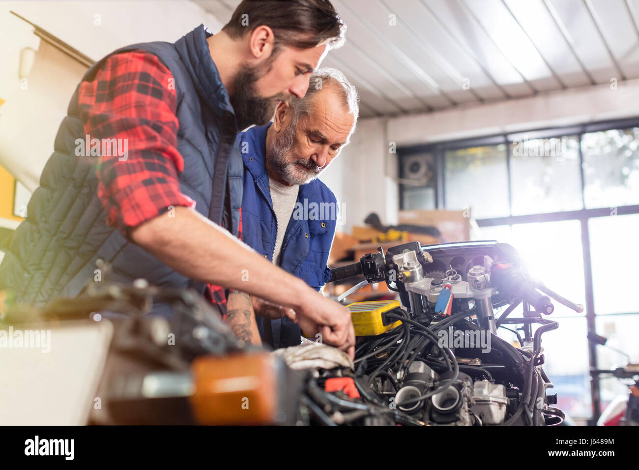 Motorcycle mechanics repairing motorcycle in workshop Stock Photo - Alamy