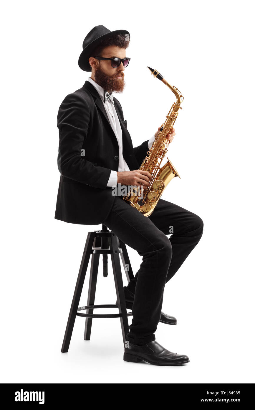 Jazz musician with a saxophone sitting on a chair isolated on white ...