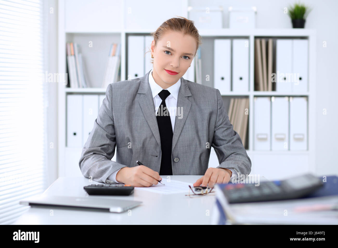 Business woman making report, calculating or checking balance Stock ...