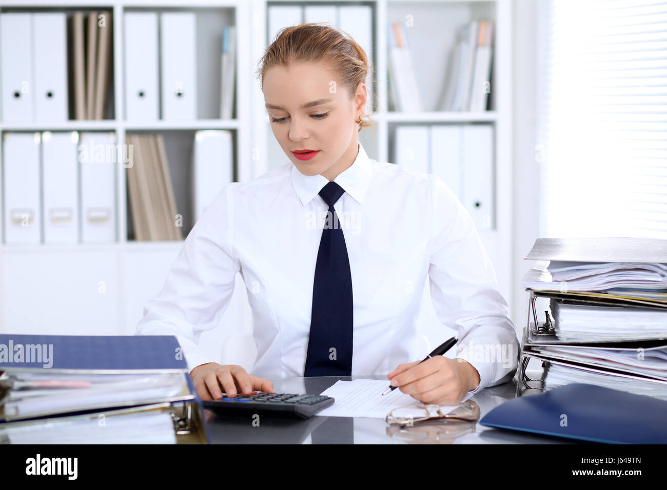 Business woman making report, calculating or checking balance Stock ...