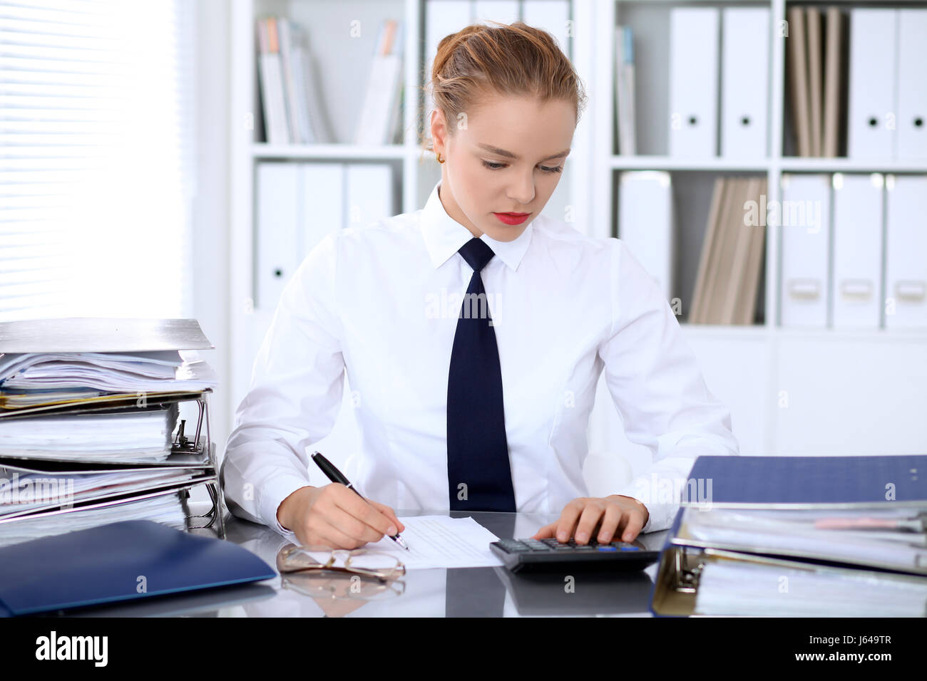 Business woman making report, calculating or checking balance Stock ...