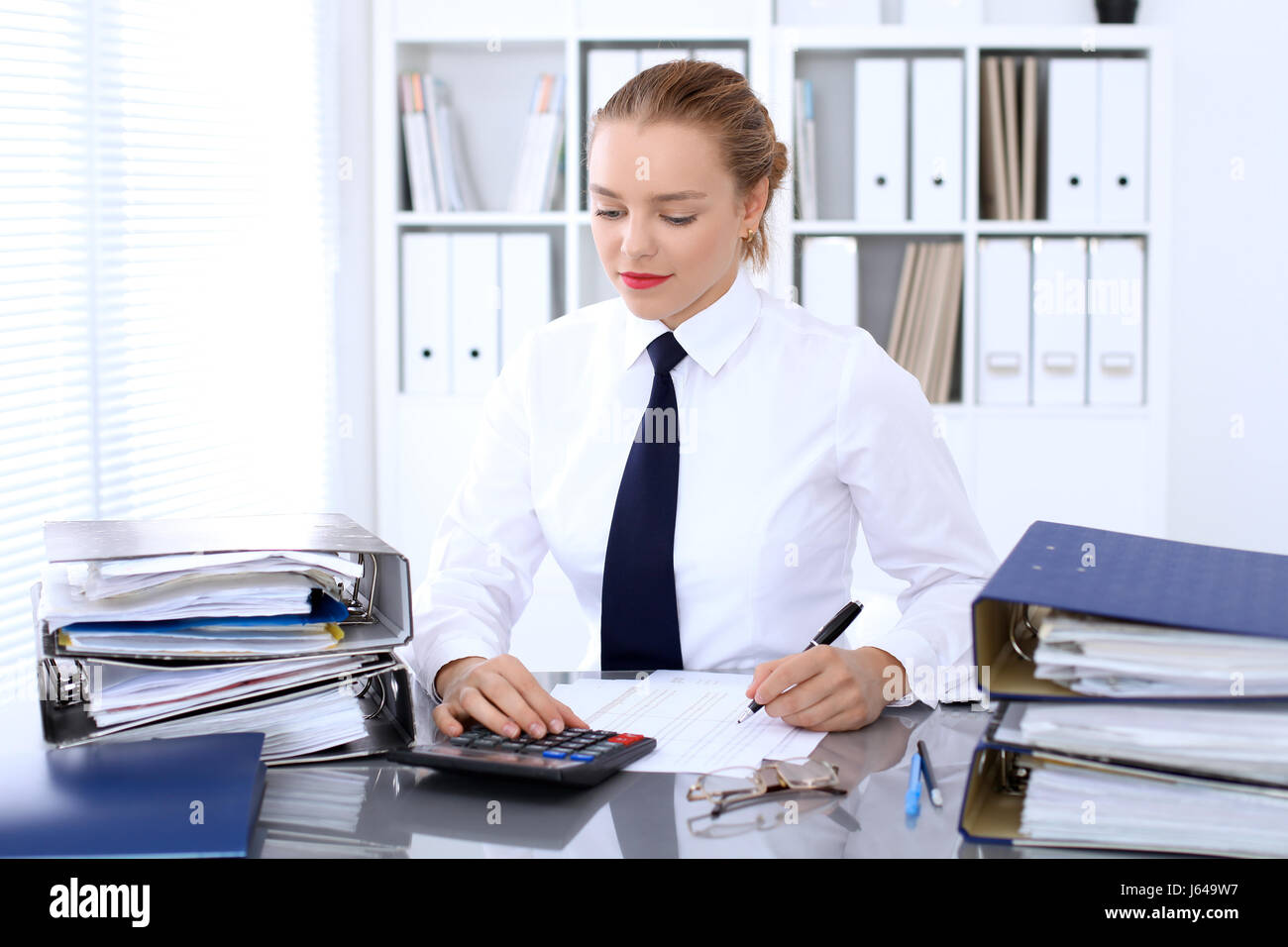 Business woman making report, calculating or checking balance Stock ...