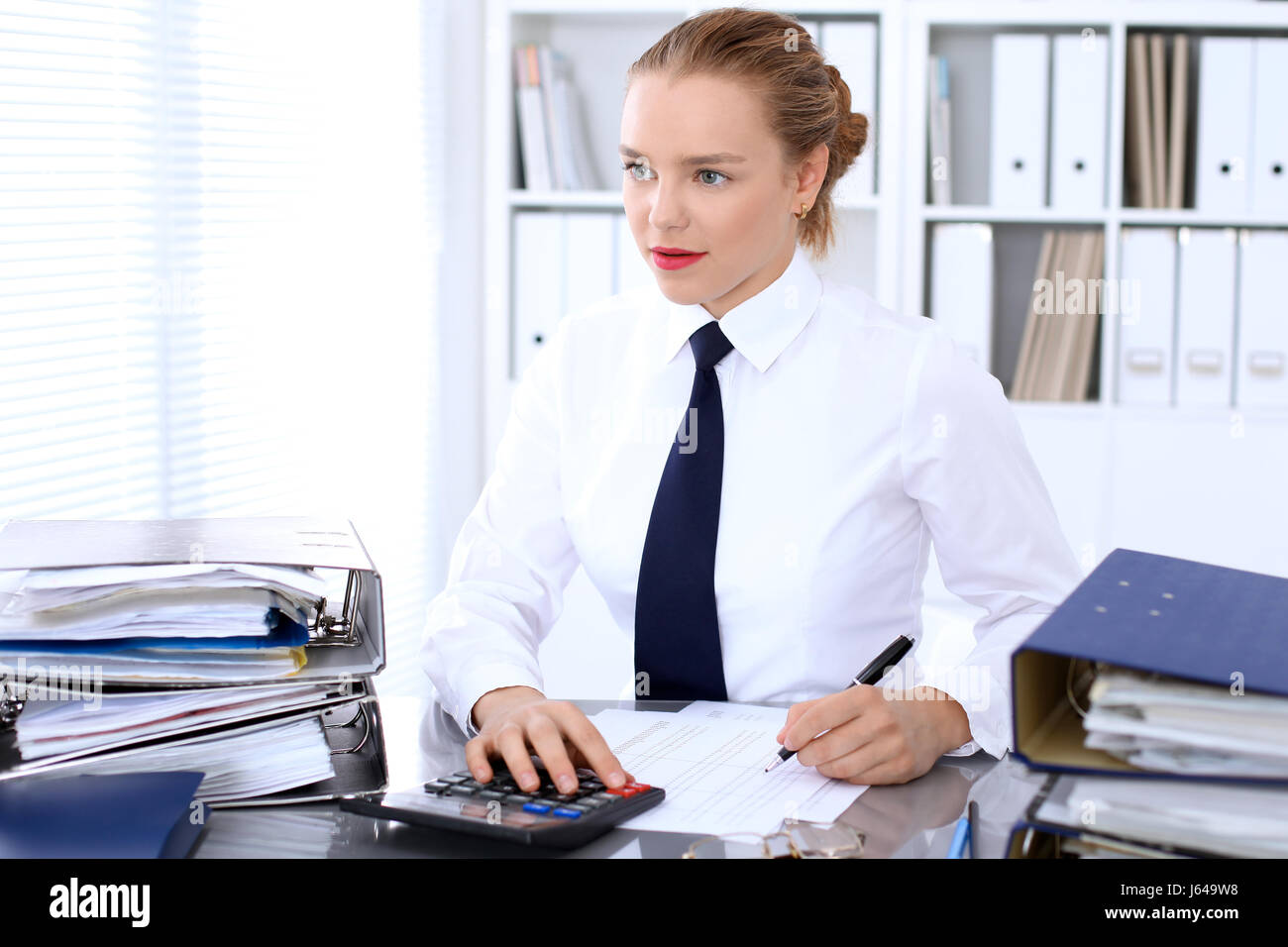 Business woman making report, calculating or checking balance Stock ...