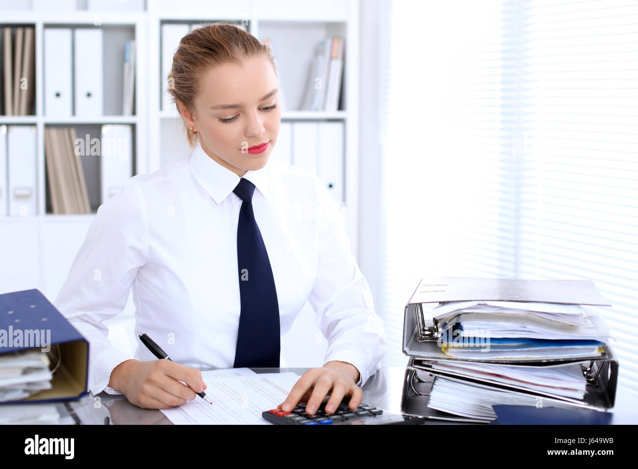 Business woman making report, calculating or checking balance Stock ...
