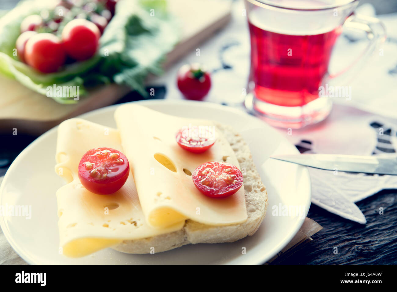 Swiss yellow cheese sandwich with cherry tomtoes Stock Photo - Alamy