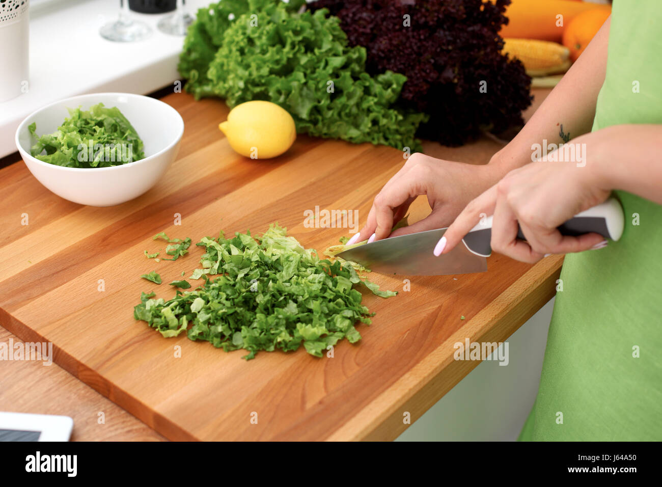 Closeup of woman hands cooking vegetables salad in kitchen. Healthy ...