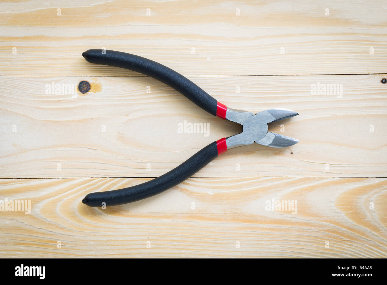 Wire cutter and wire cutter on wooden floor Stock Photo - Alamy