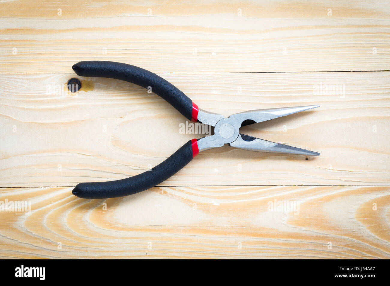 Wire clamp pliers cut the wires on the wooden floor Stock Photo - Alamy