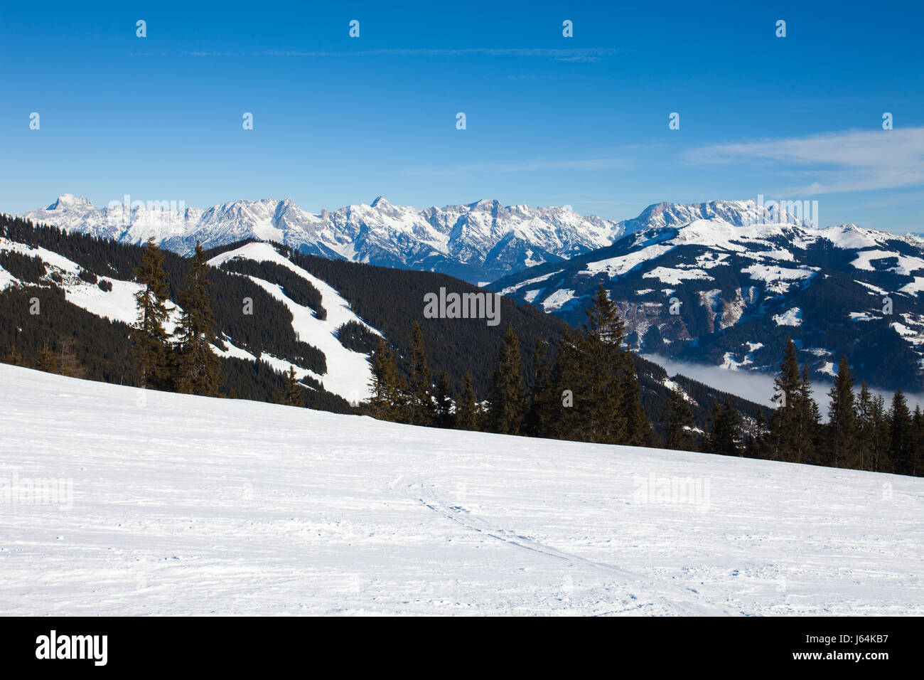 winter with ski slopes of kaprun resort next to kitzsteinhorn peak in ...