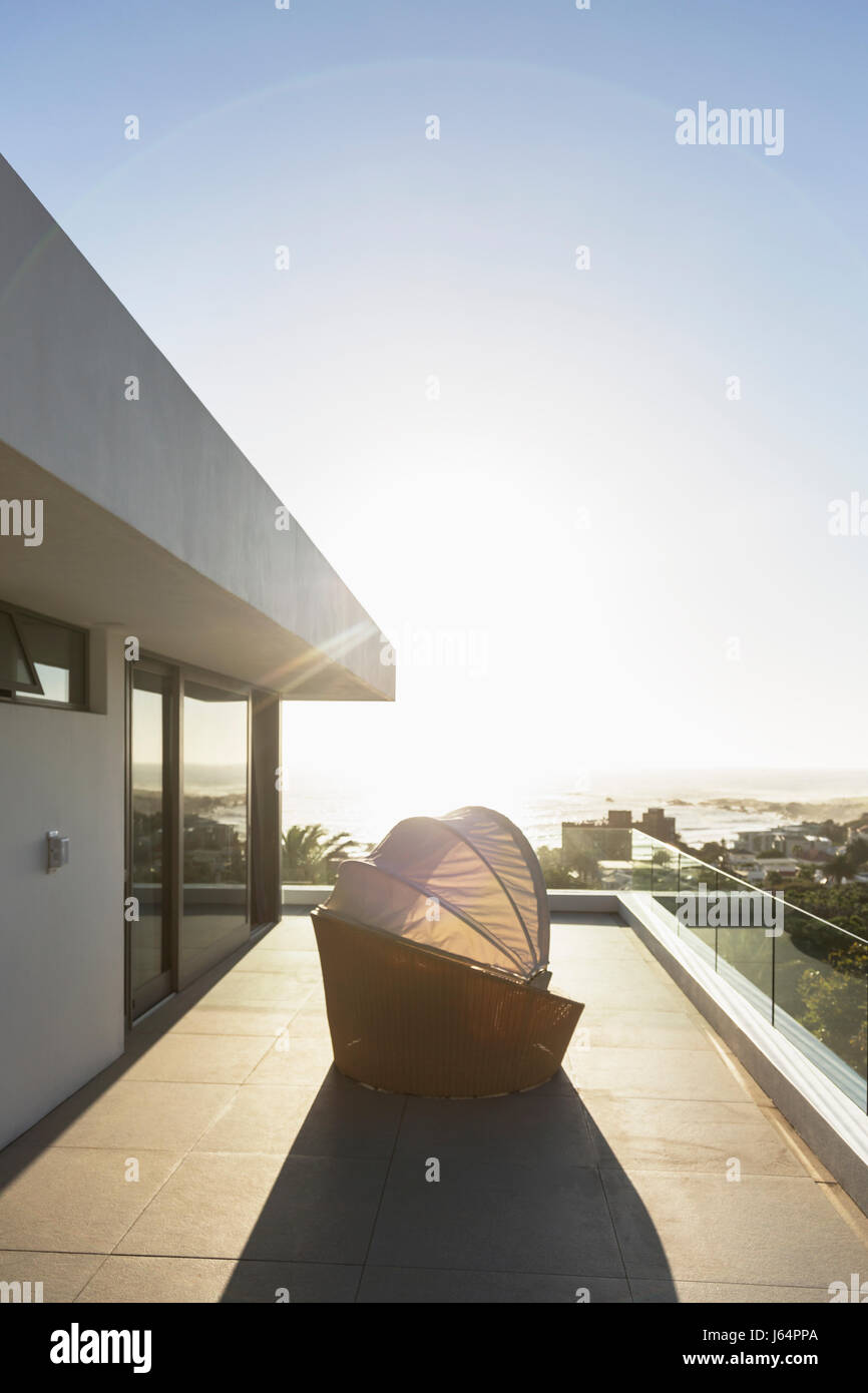 Covered patio chair on sunny modern luxury balcony under blue sky Stock ...