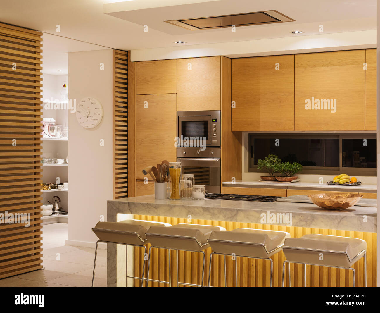 Wooden cupboards in modern luxury home showcase kitchen Stock Photo - Alamy