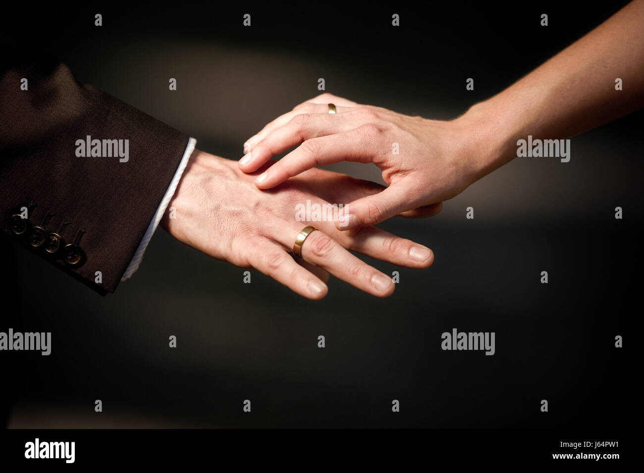 hand in hand with wedding ring Stock Photo - Alamy