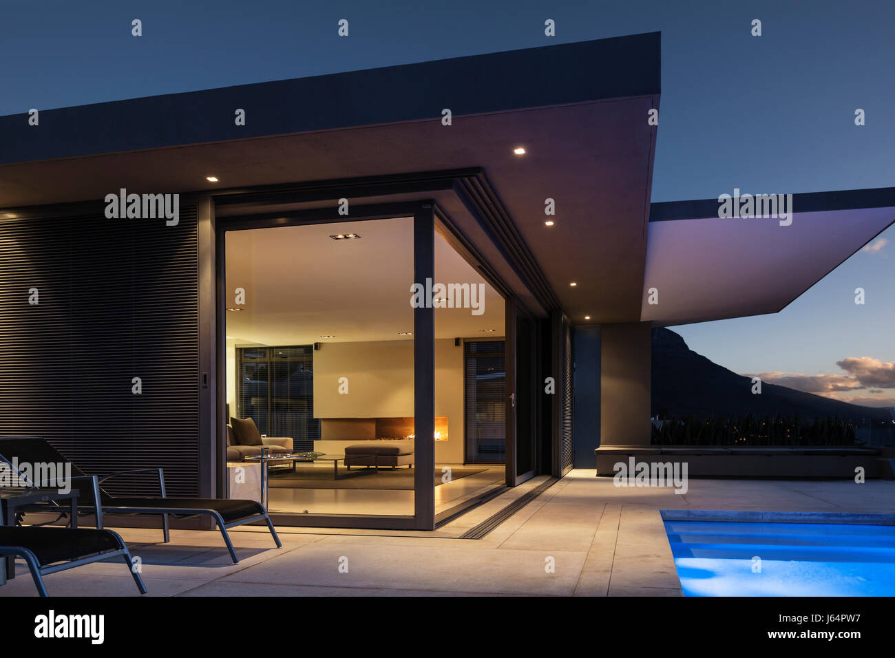 Illuminated modern home showcase exterior at night Stock Photo - Alamy