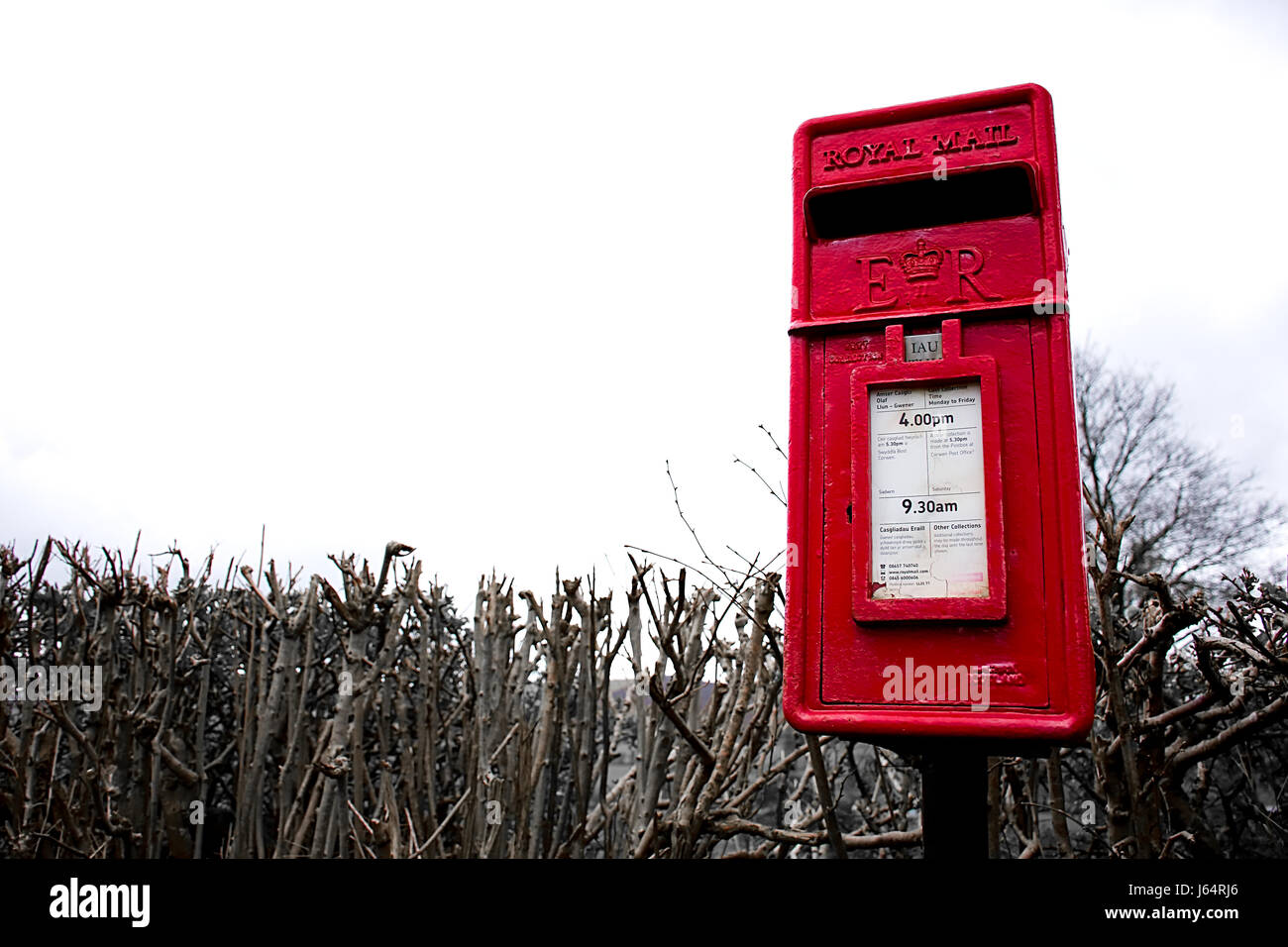 Letter box in rural location on british countryside.British red,small ...