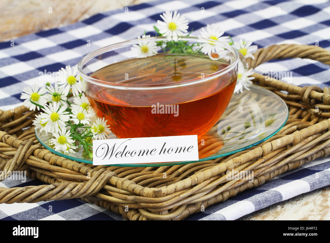 Welcome home card with cup of chamomile tea on wicker tray Stock Photo ...