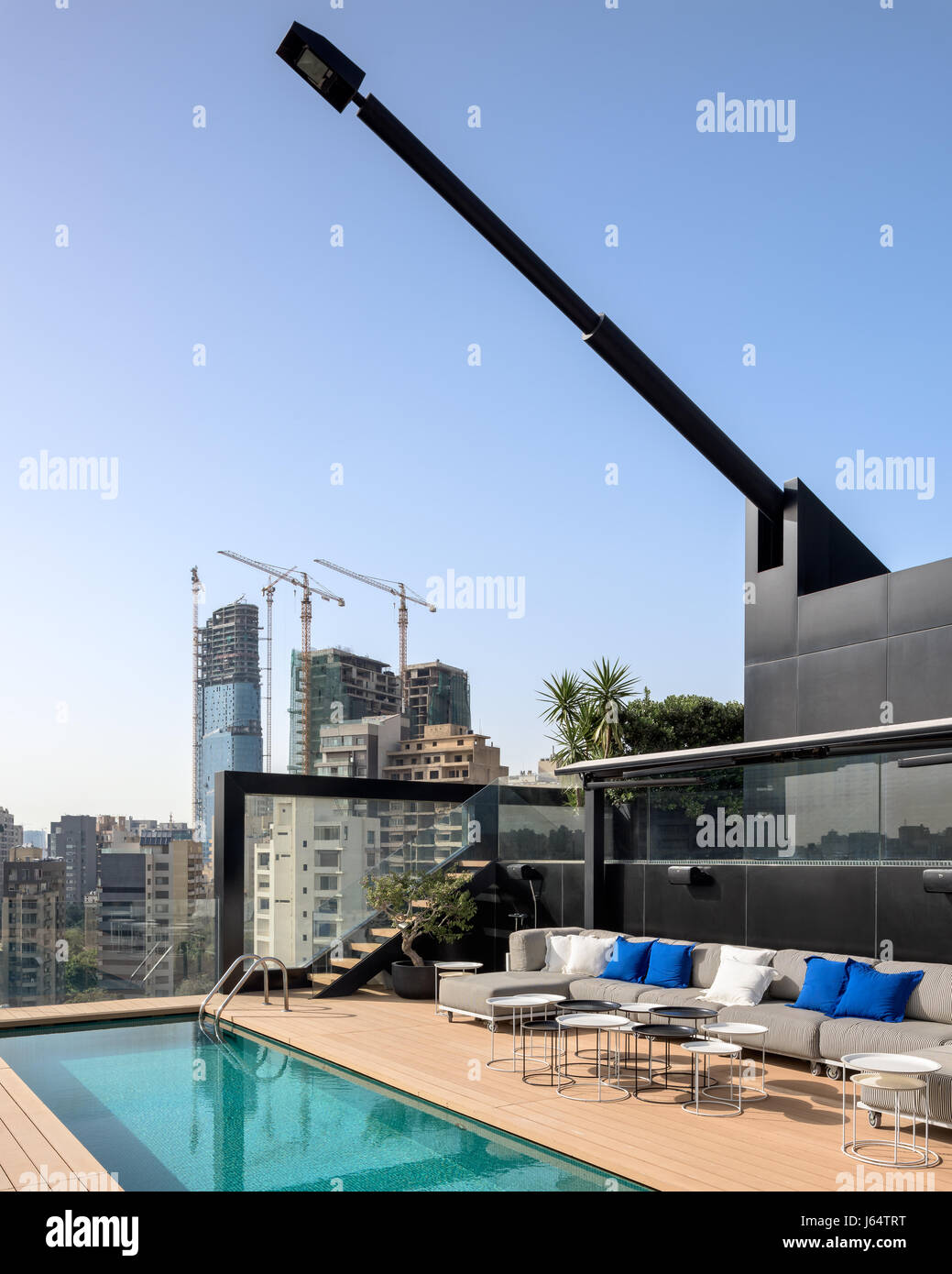 Roof top swimming pool with pair of Khoury-designed black pivotting ...
