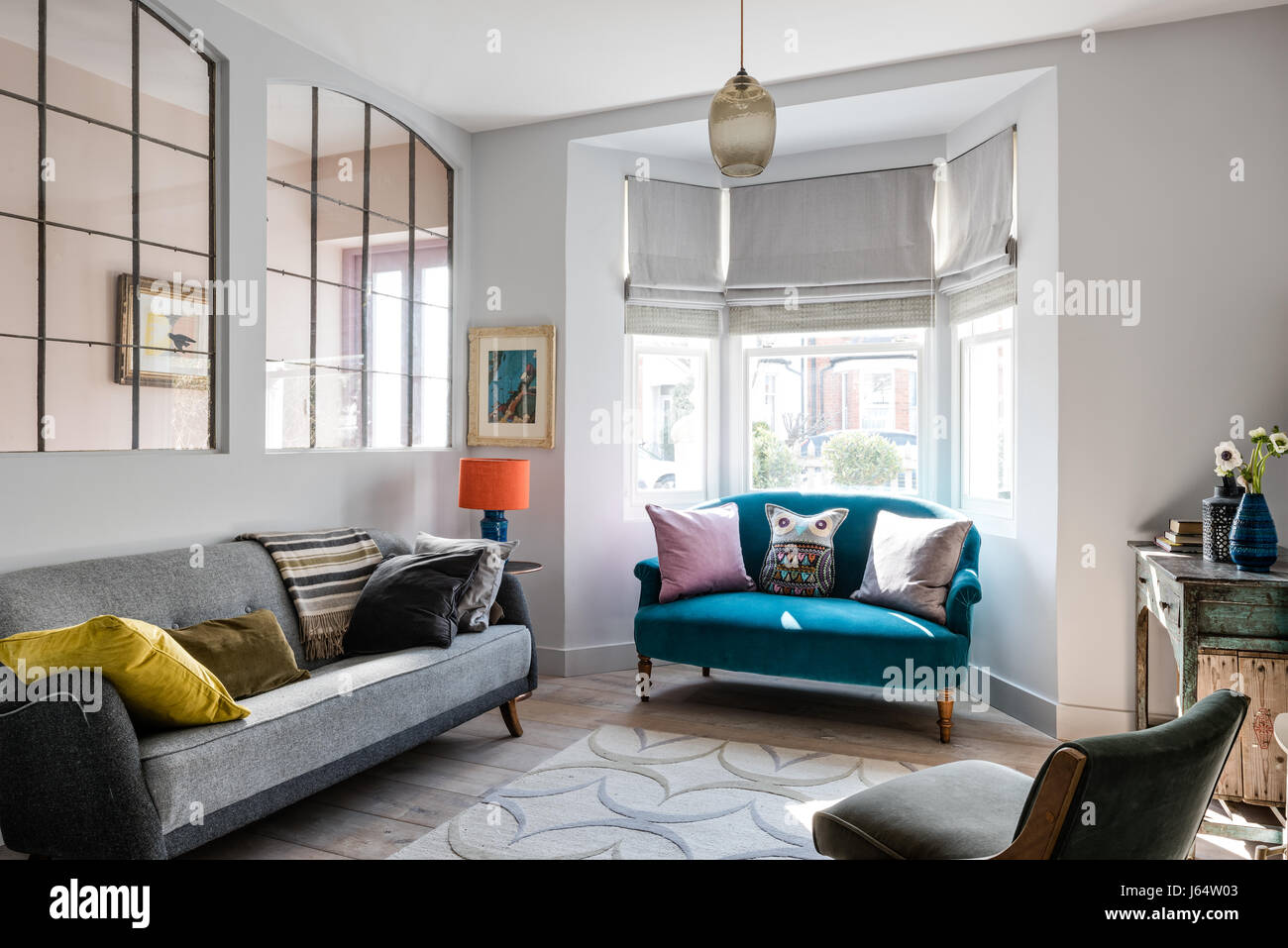 Large french metal salvaged windows in sitting room with grey vintage ...
