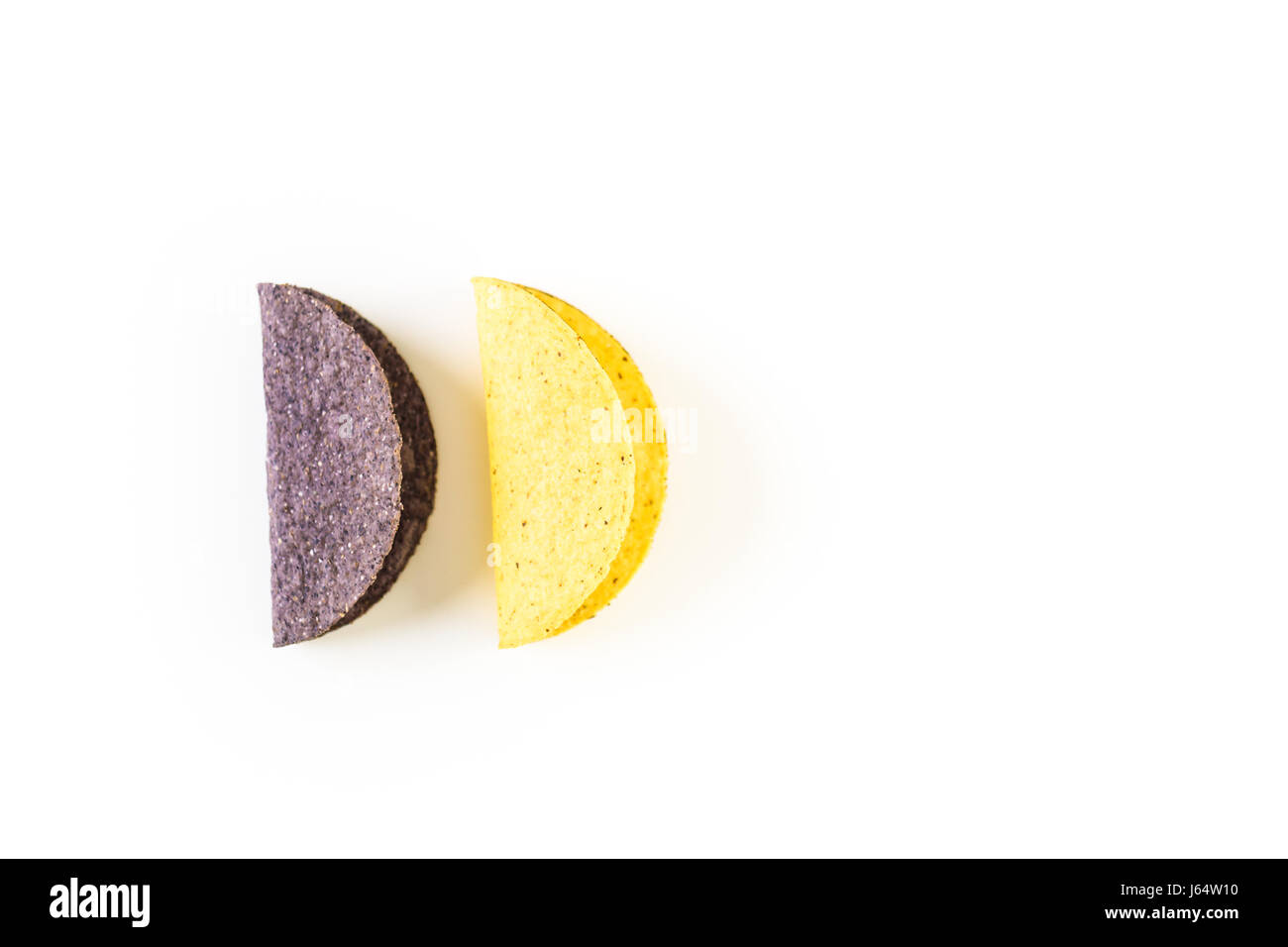 Blue and yellow corn taco shells on a white background Stock Photo - Alamy