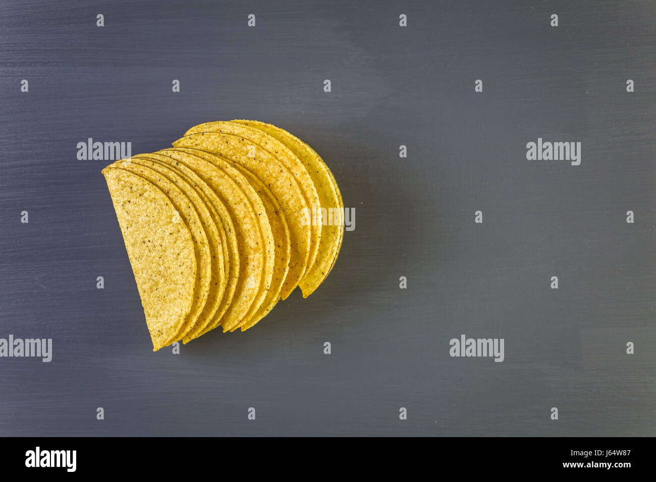 Yellow corn taco shells on a gray background Stock Photo - Alamy
