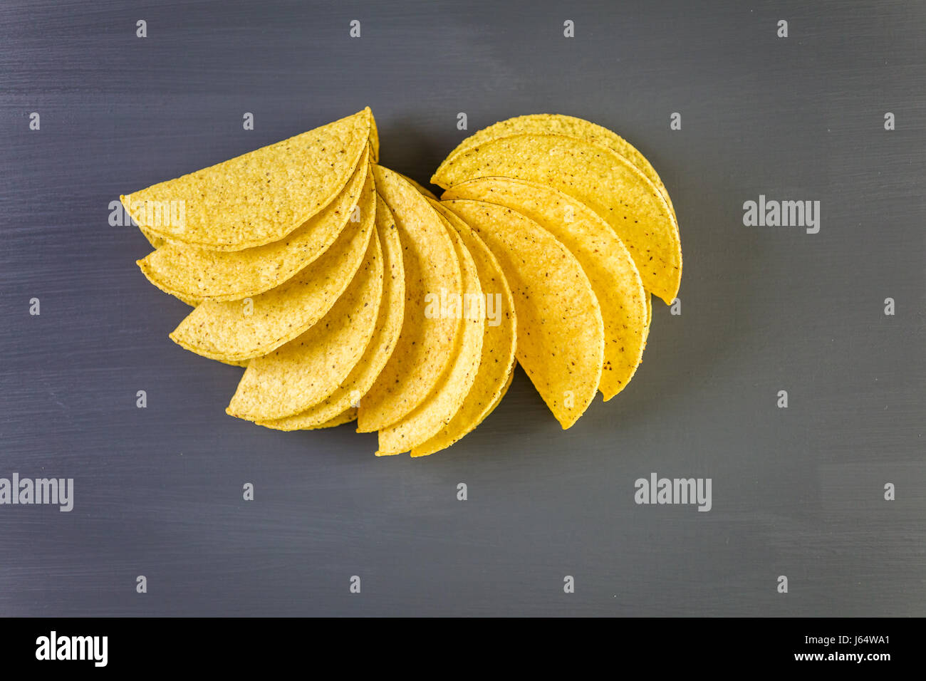 Yellow corn taco shells on a gray background Stock Photo - Alamy