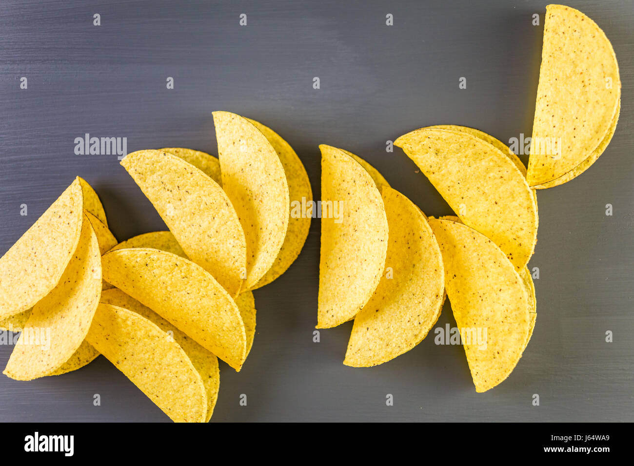 Yellow corn taco shells on a gray background Stock Photo - Alamy