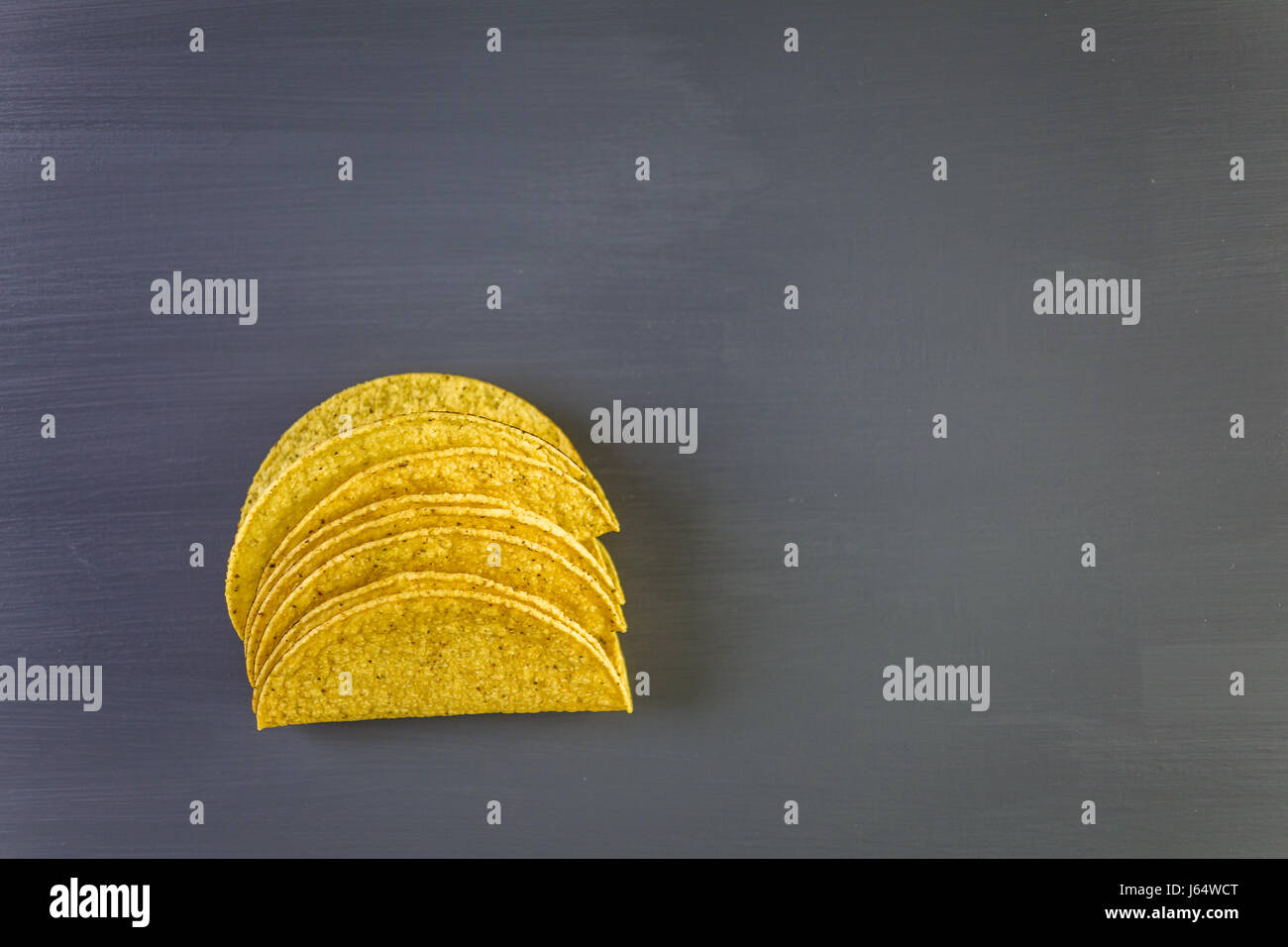 Yellow corn taco shells on a gray background Stock Photo - Alamy
