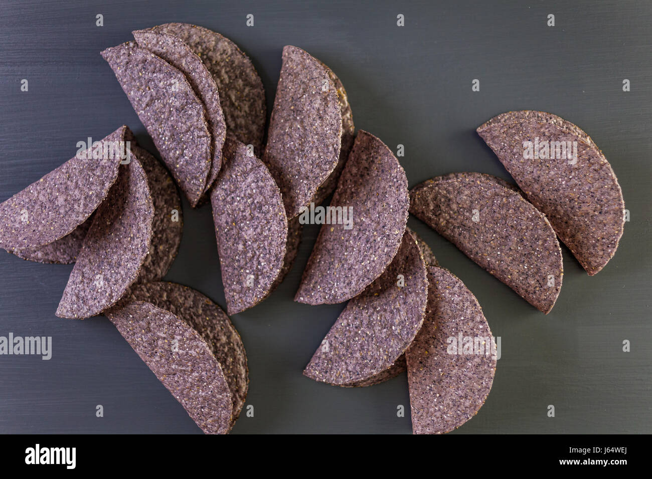 Blue corn taco shells on a gray background Stock Photo - Alamy